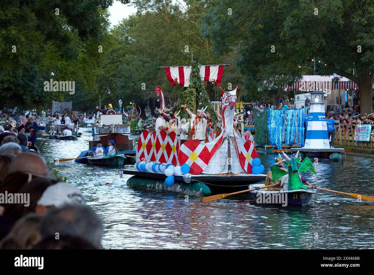 A procession of decorated boats and barges form a floating parade along ...
