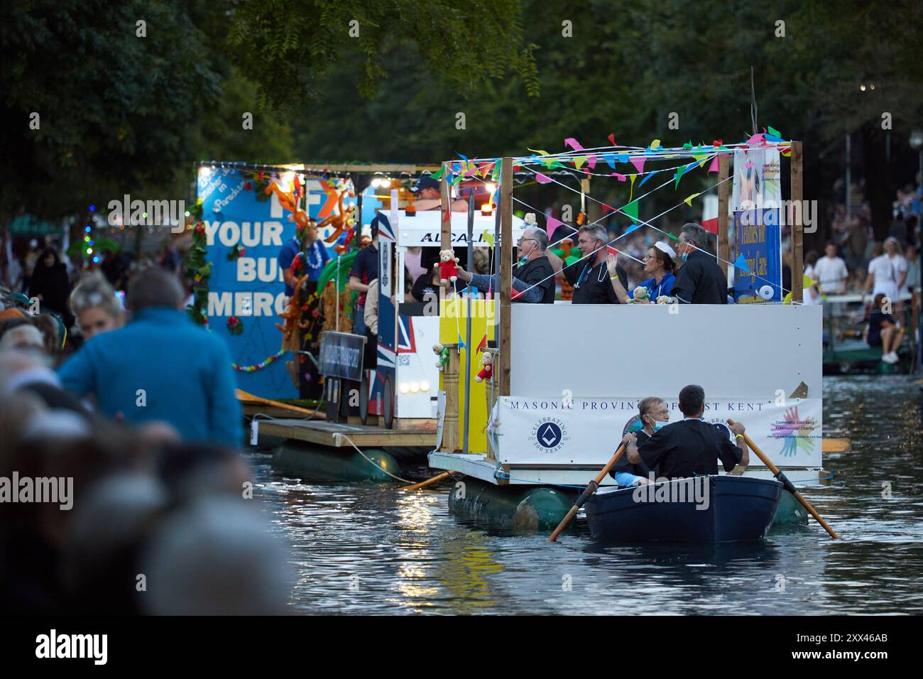 A procession of decorated boats and barges form a floating parade along ...
