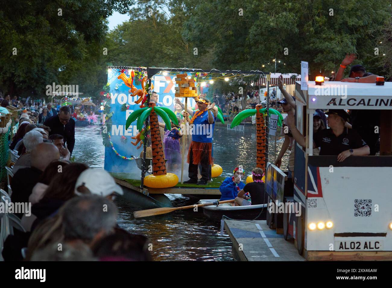A procession of decorated boats and barges form a floating parade along ...