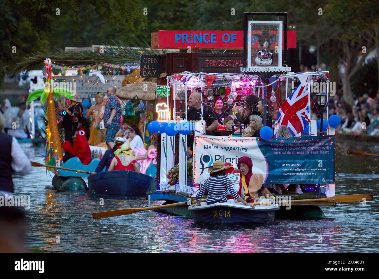 A procession of decorated boats and barges form a floating parade along ...