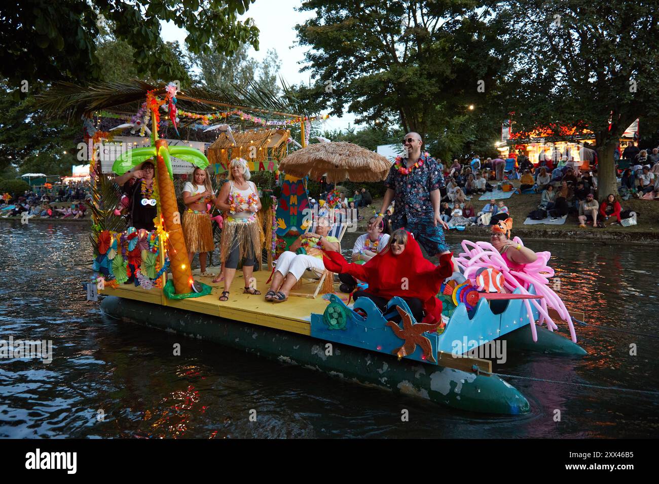 A procession of decorated boats and barges form a floating parade along ...