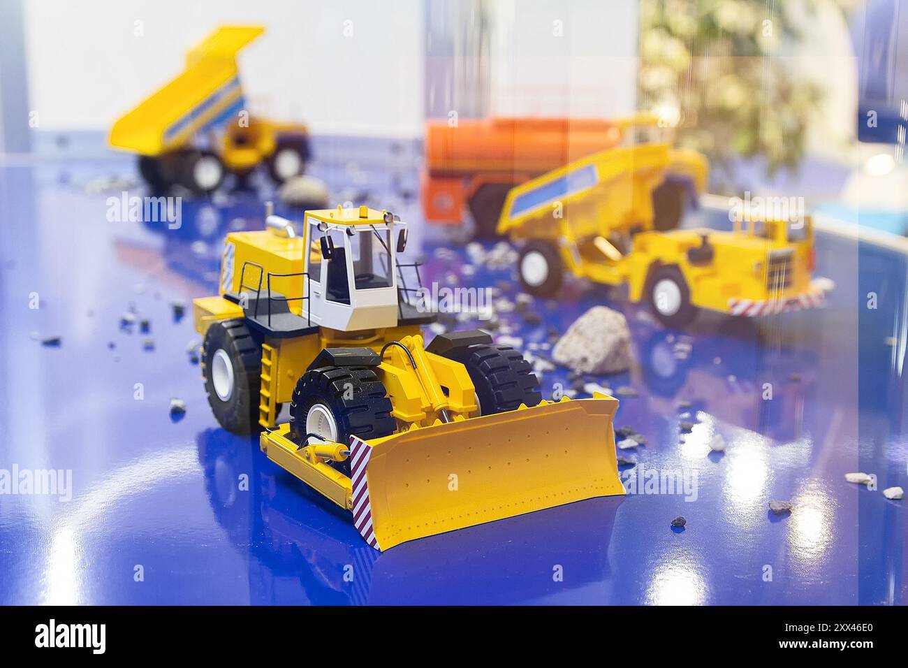 Models of bulldozer and other mining equipment at the exhibition stand ...