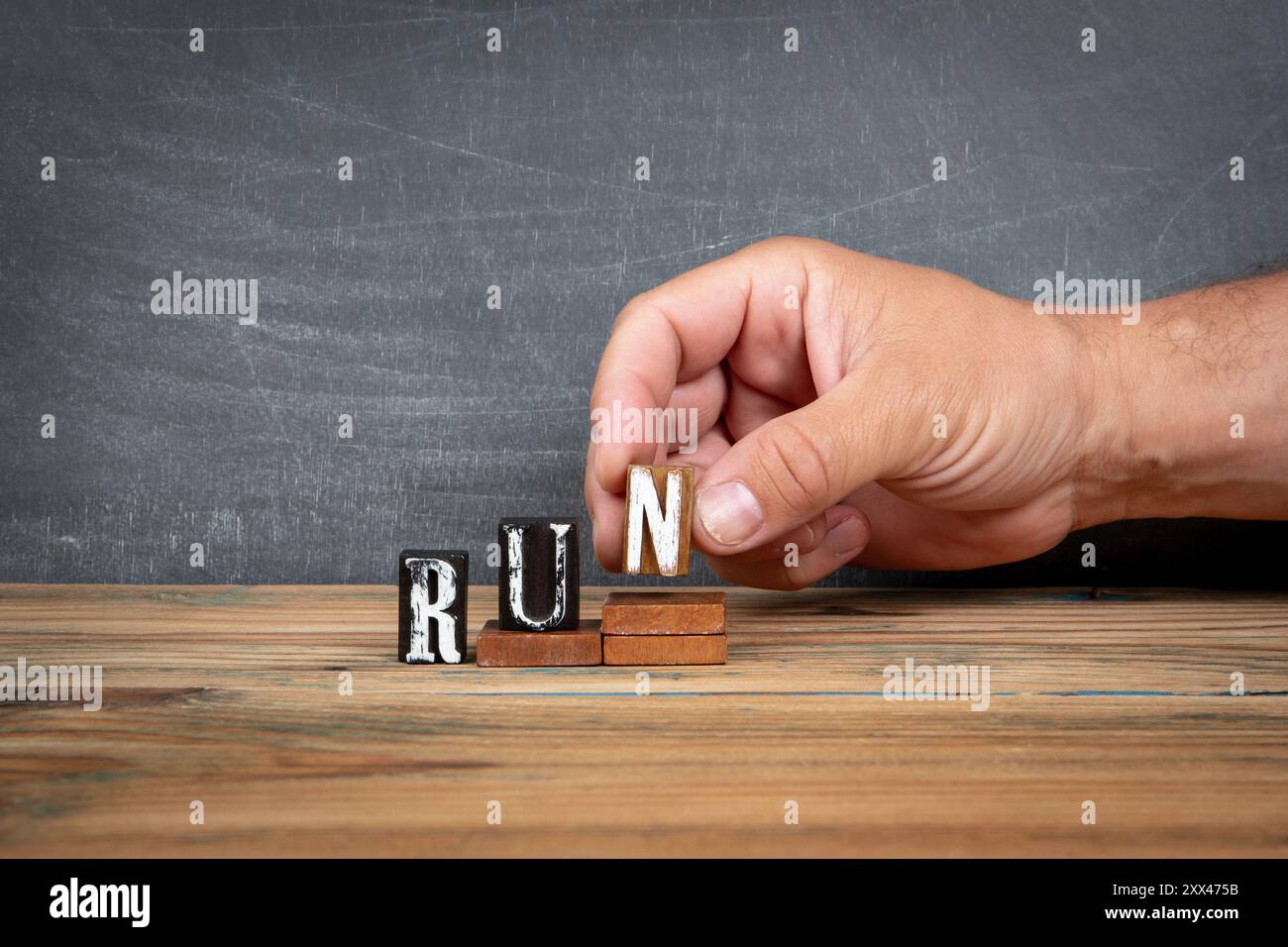 RUN. Wooden letters, alphabet blocks on steps. development and growth ...
