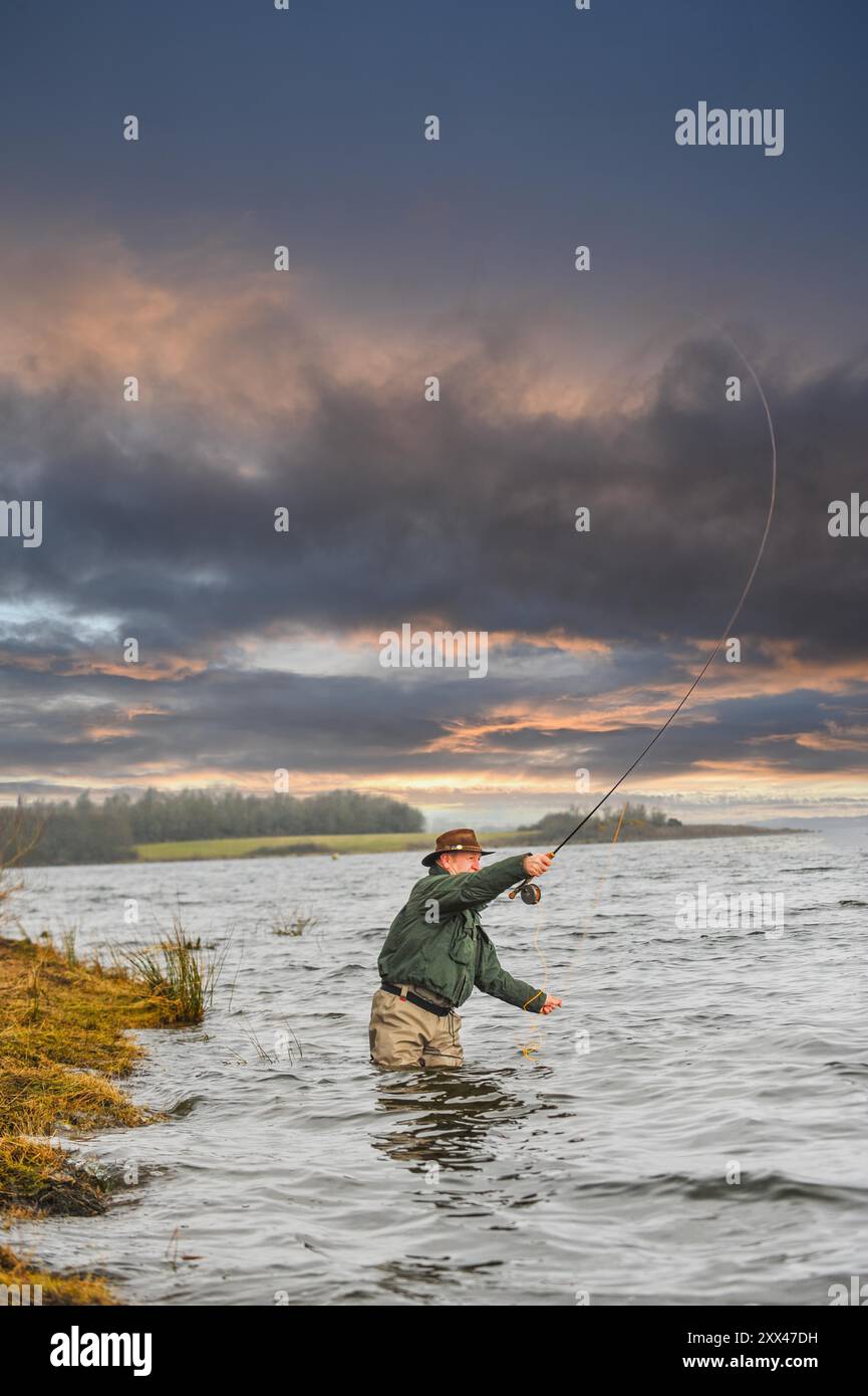a white man, fishing , casting a rod, standing in the water Stock Photo ...