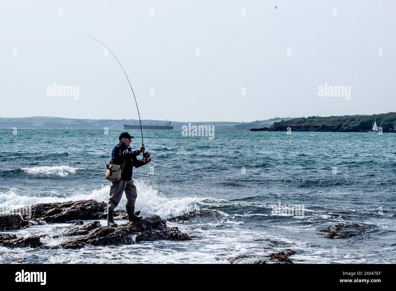 Fisherman fishing from beach hi-res stock photography and images - Alamy