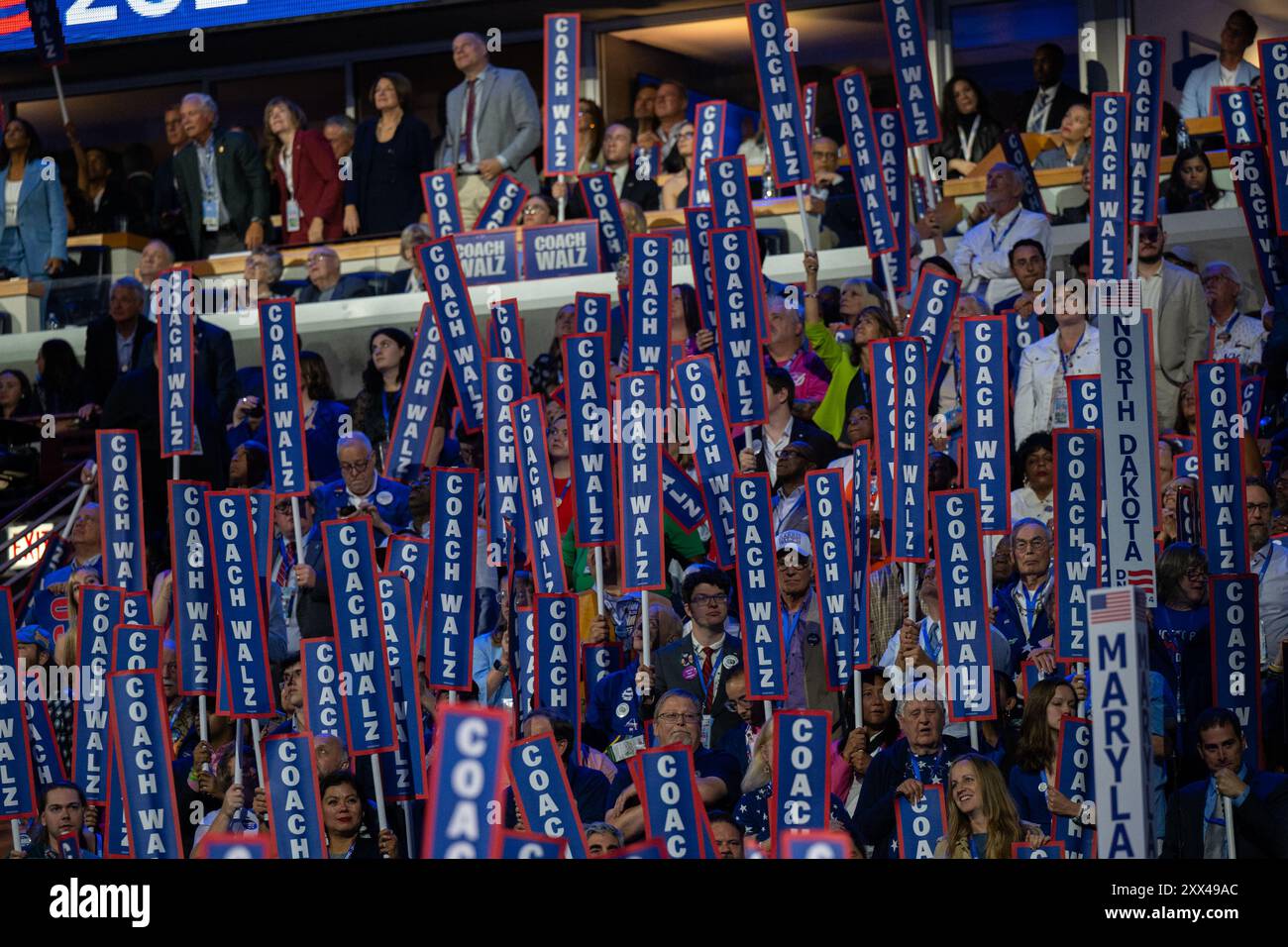 People hold signs that say “Coach Walz” as Governor Tim Walz (Democrat ...