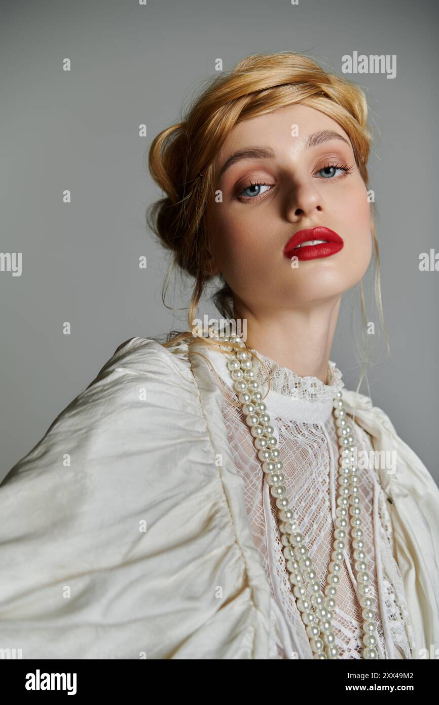 A young woman in a white lace blouse with blonde hair, red lipstick ...