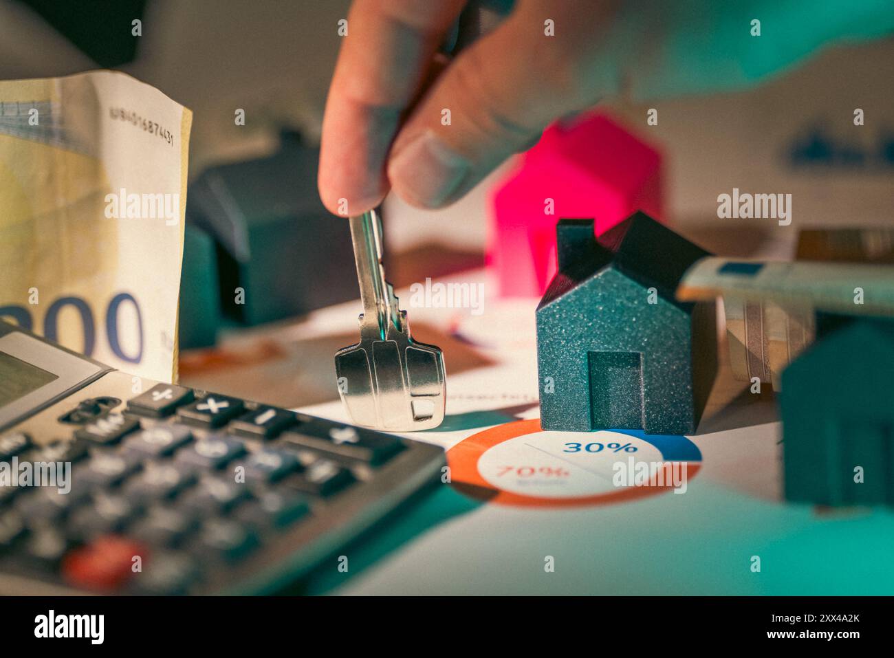 Housing investment financing prices. Hand holding key to new house door ...