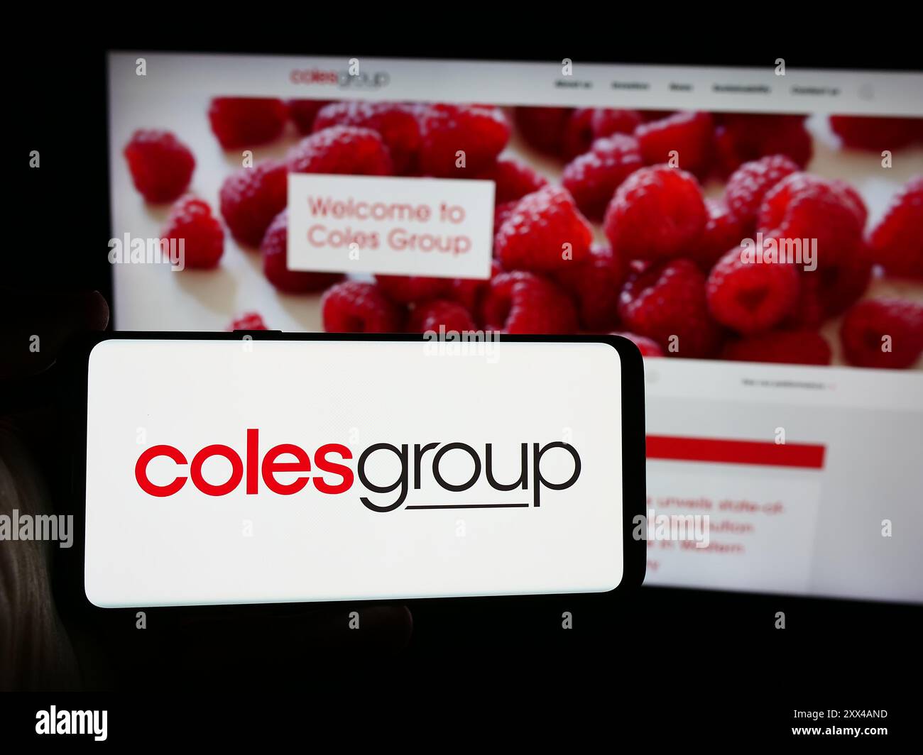 Person holding smartphone with logo of Australian retail company Coles ...