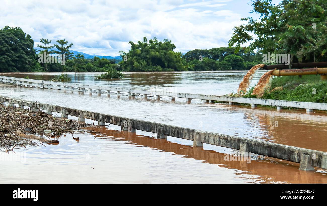 An image of a concrete bridge submerged in floodwater, illustrating the ...