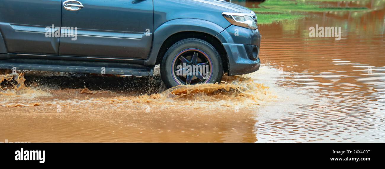 Floodwater splashing violently caused by a vehicle which are driven ...