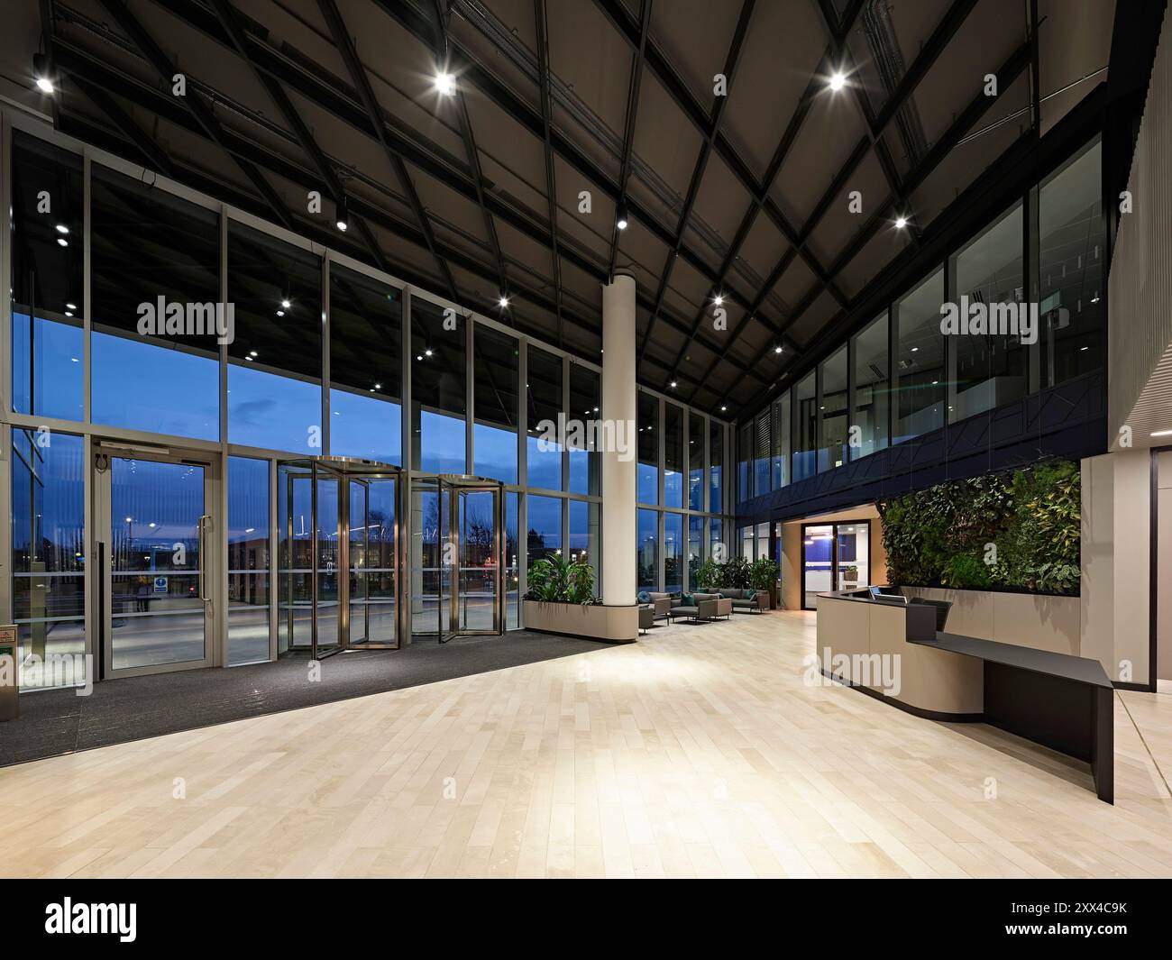 Double-height reception at dusk. Building 1180, Reading, United Kingdom ...