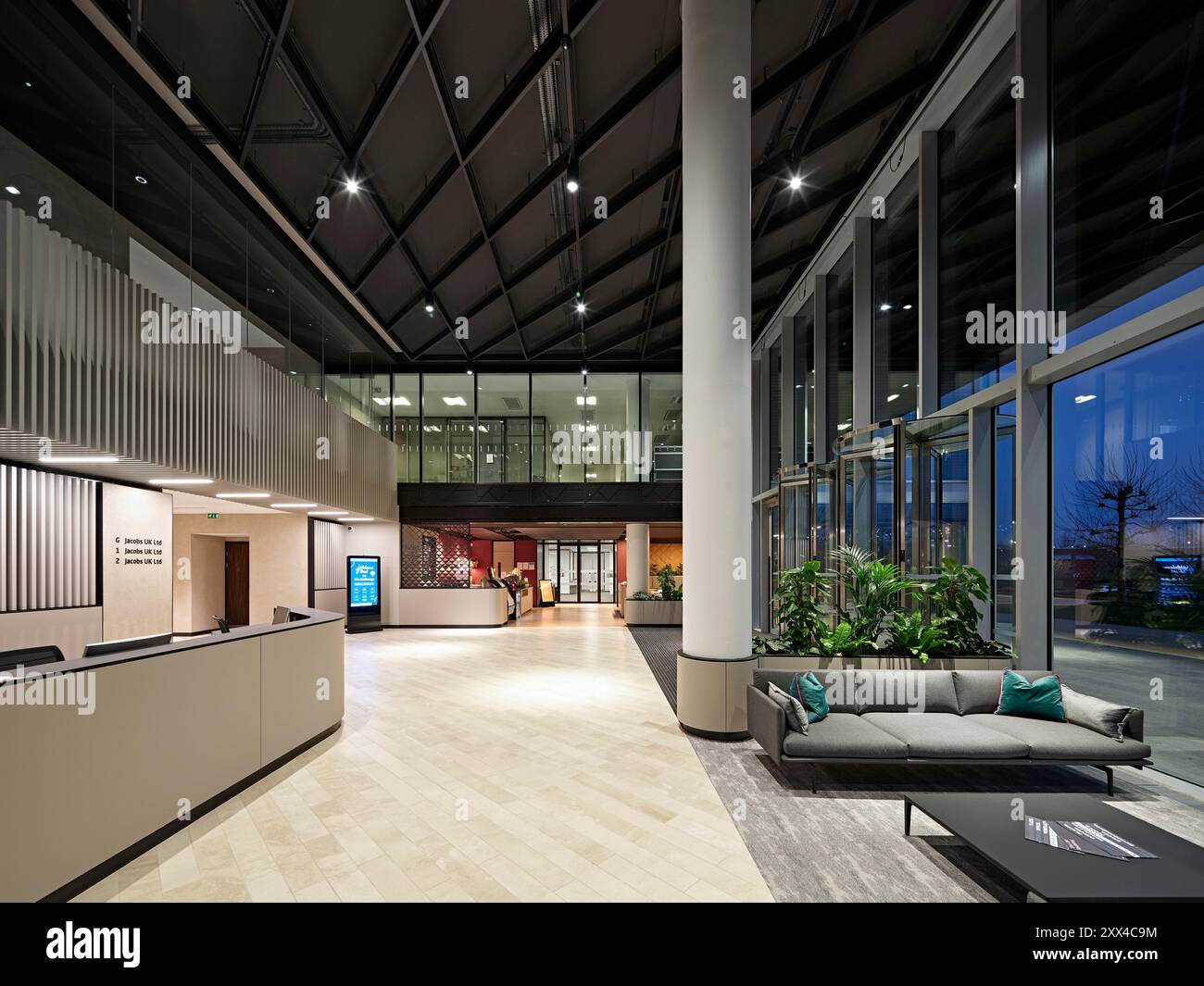 Double-height reception at dusk. Building 1180, Reading, United Kingdom ...