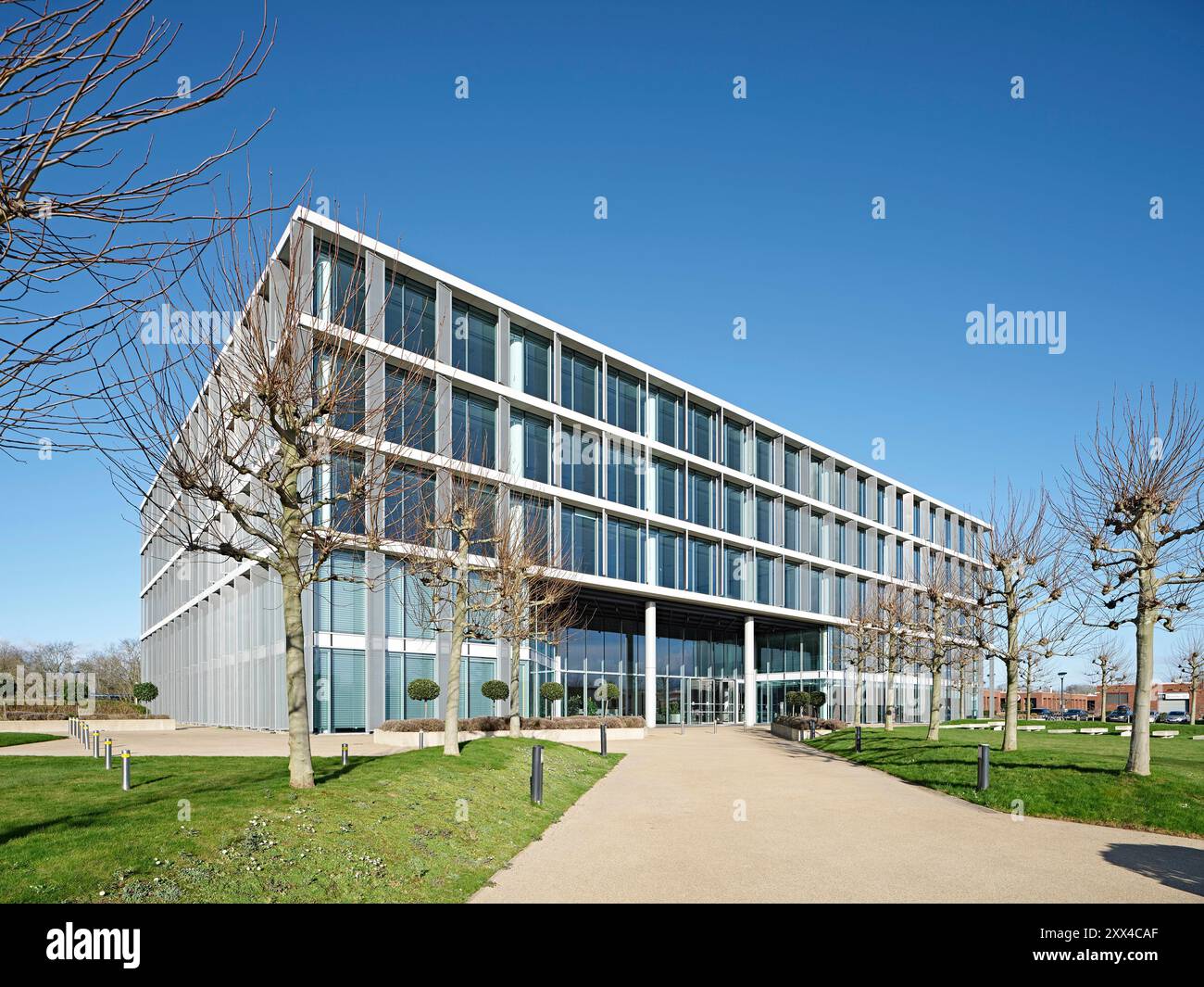 Sunlit oblique elevation of office building from approach. Building ...