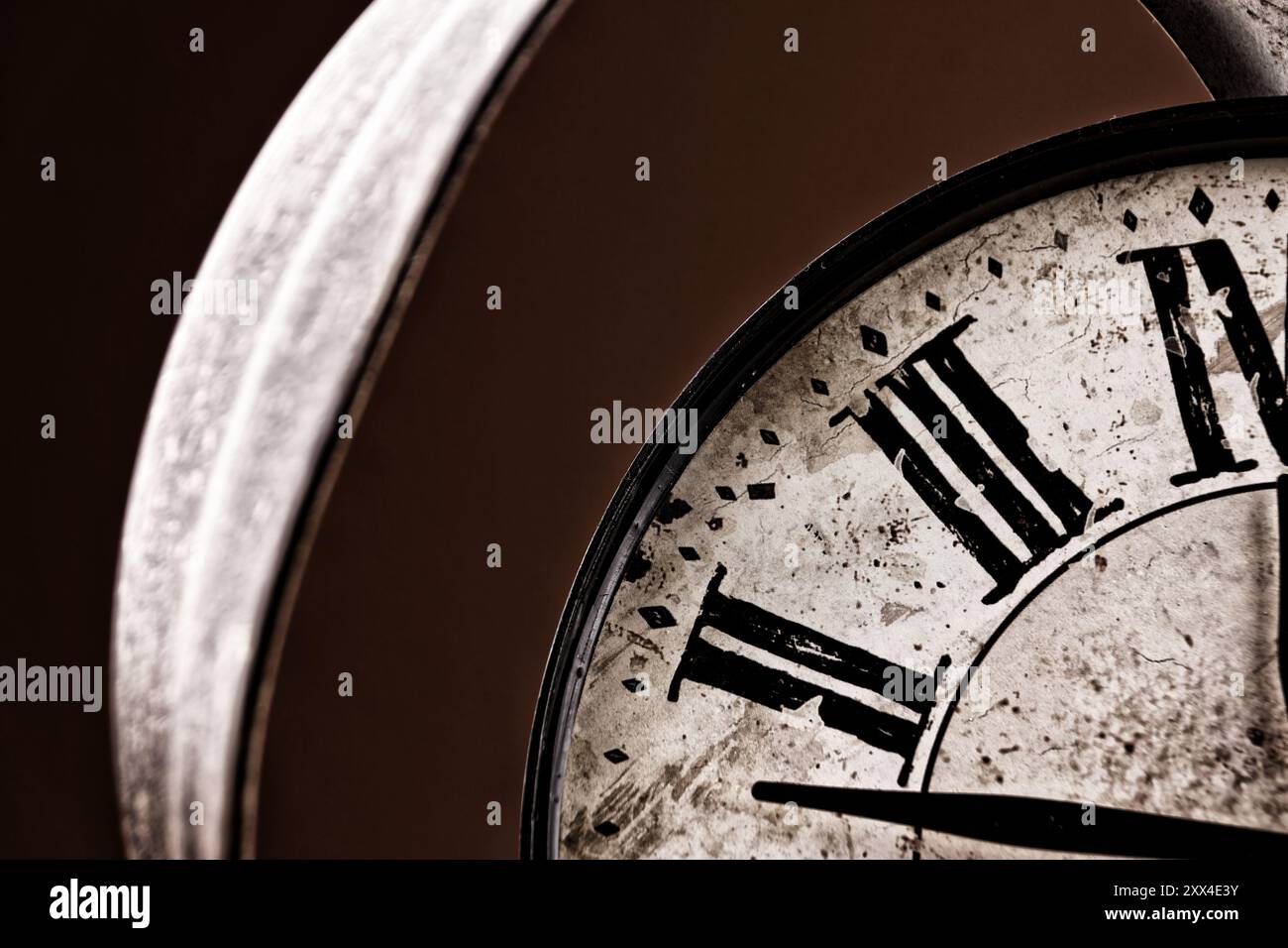 Broken old analog clock with glass and metal frame on wooden table ...