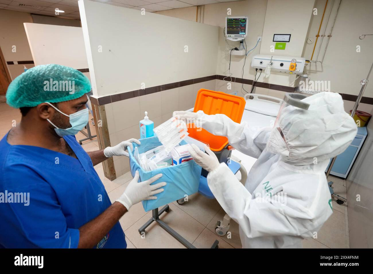 Paramedical staff prepare an isolation ward set up as a preventative ...