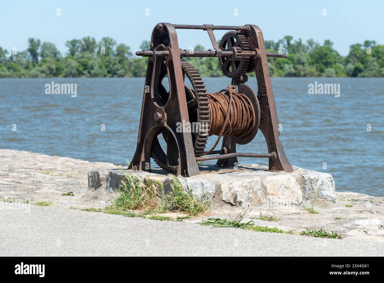 An old metal winch on the side of river in Belgrade, years of rust and ...