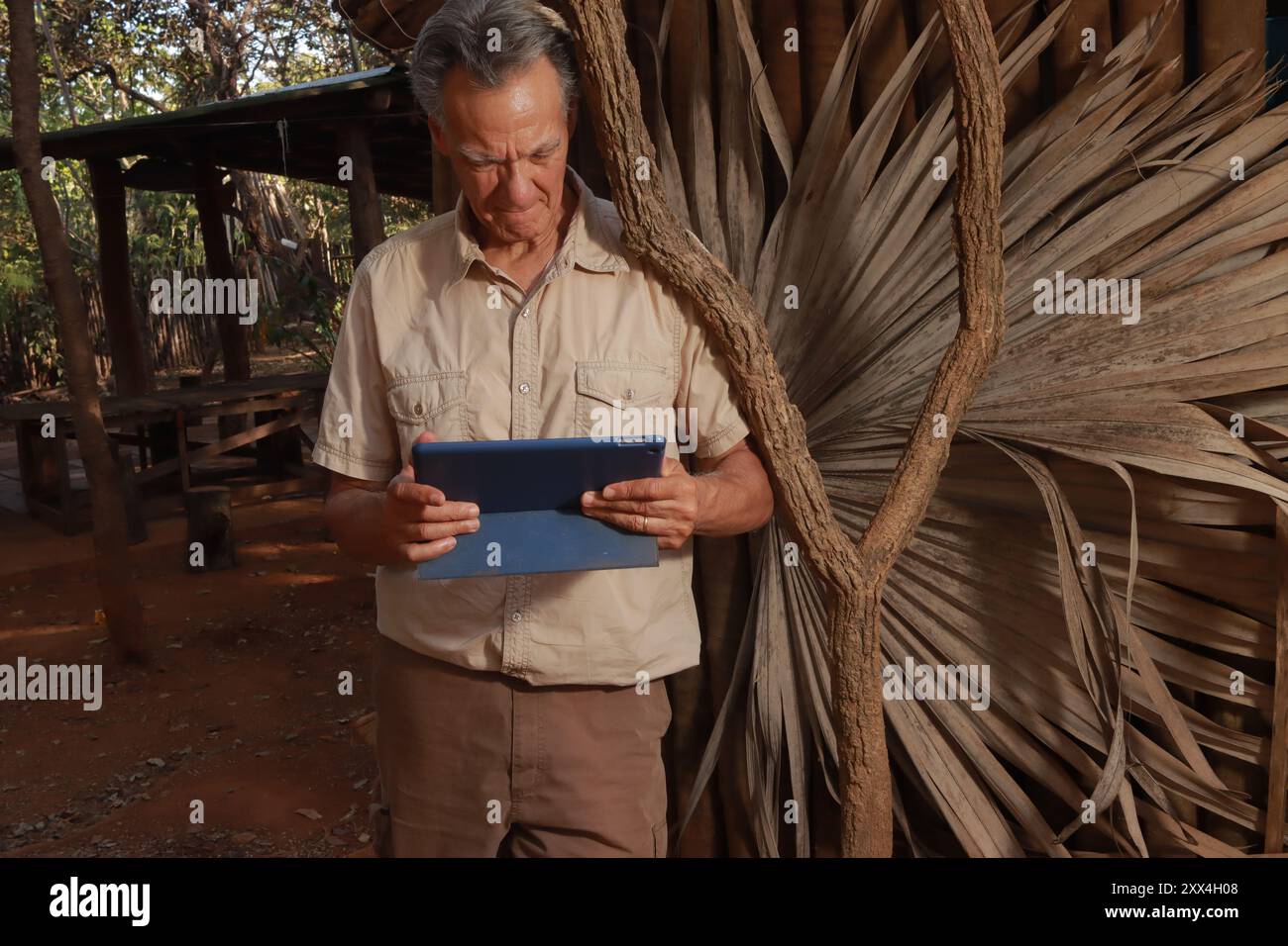 Field Biologist at a research station out in the Amazon recording notes ...
