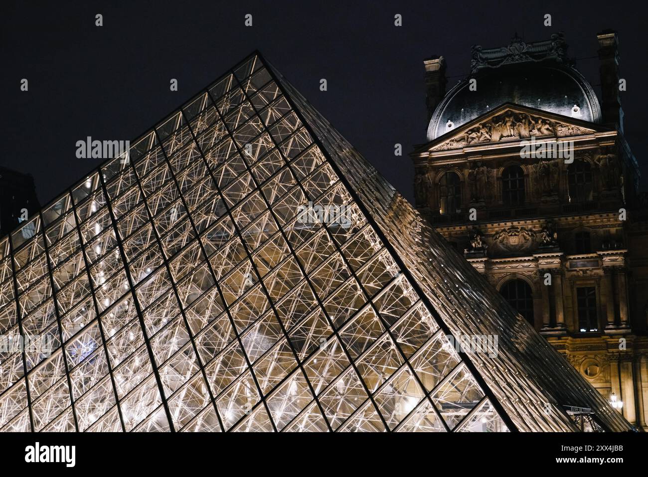 Night view of the Louvre Pyramid and the historic Louvre Palace in ...