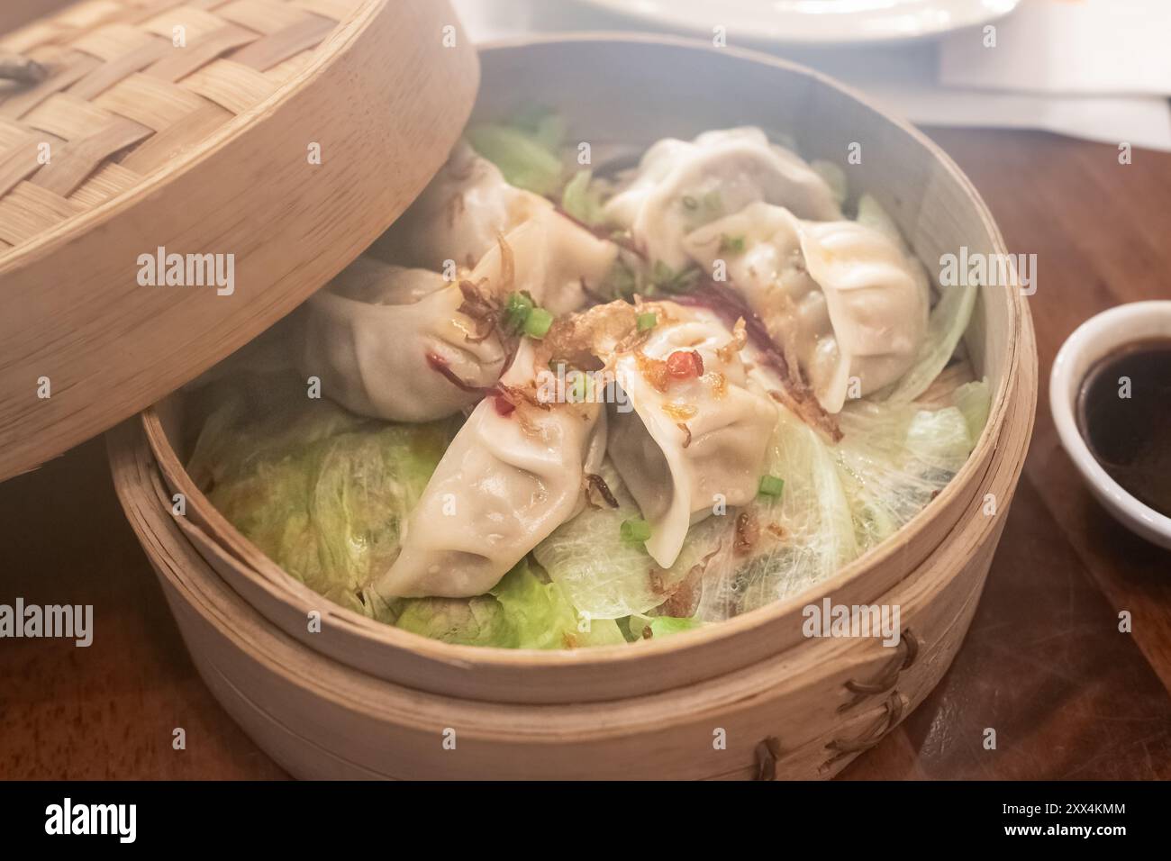 Traditional Asian Chinese dumplings cooked in a bamboo pot. Gyoza ...