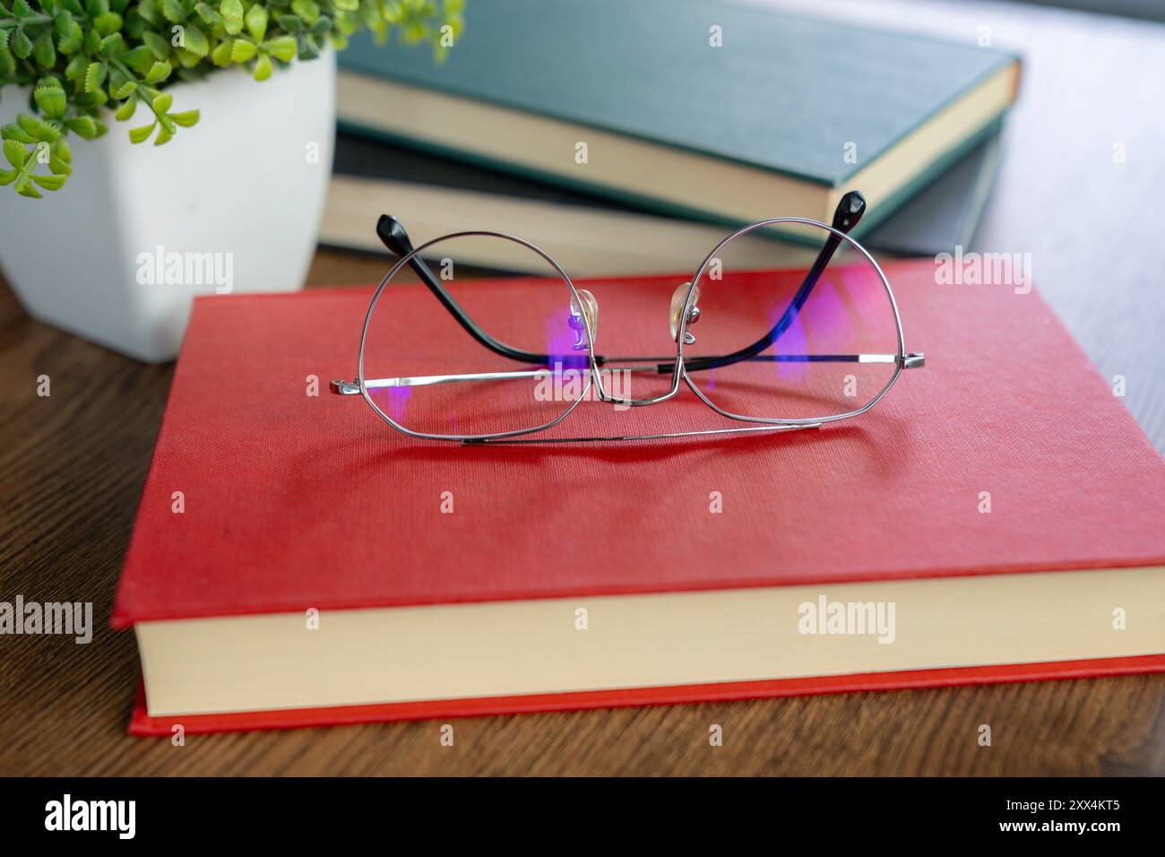 Eyeglasses resting on stack hi-res stock photography and images - Alamy
