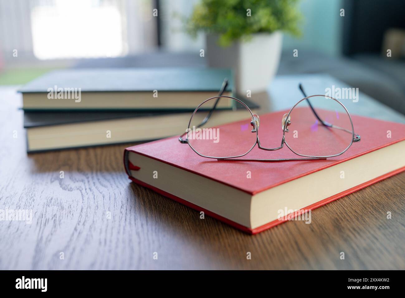 Eyeglasses resting on stack hi-res stock photography and images - Alamy