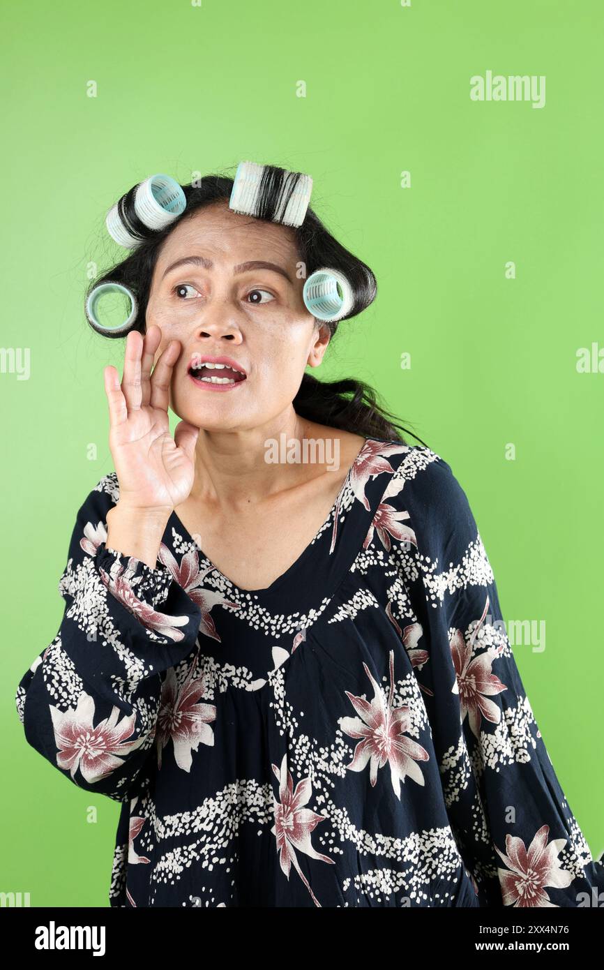 Middle Age Indonesian Woman Wearing Hail Roll and Daster Holding Hand ...