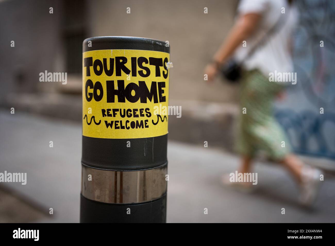 Barcelona, Spain - 21 August 2024: A graffiti reading "tourists go home ...