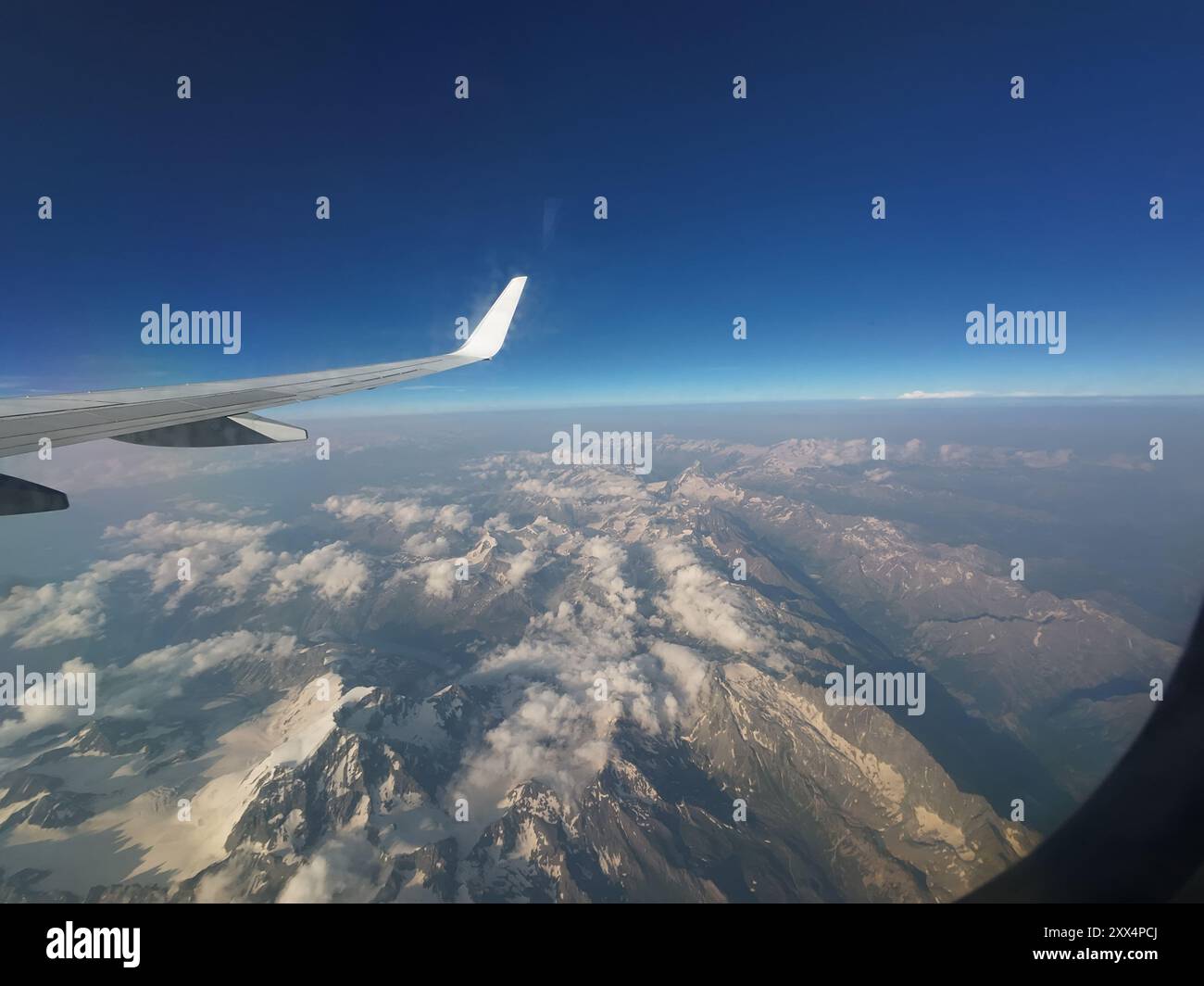 Wing of an airplane flying over alps hi-res stock photography and ...