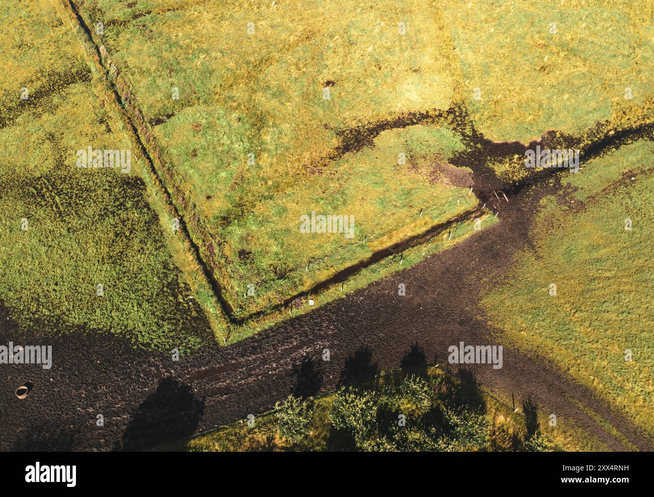 Aerial view of a drainage ditch through a field or pasture in central ...
