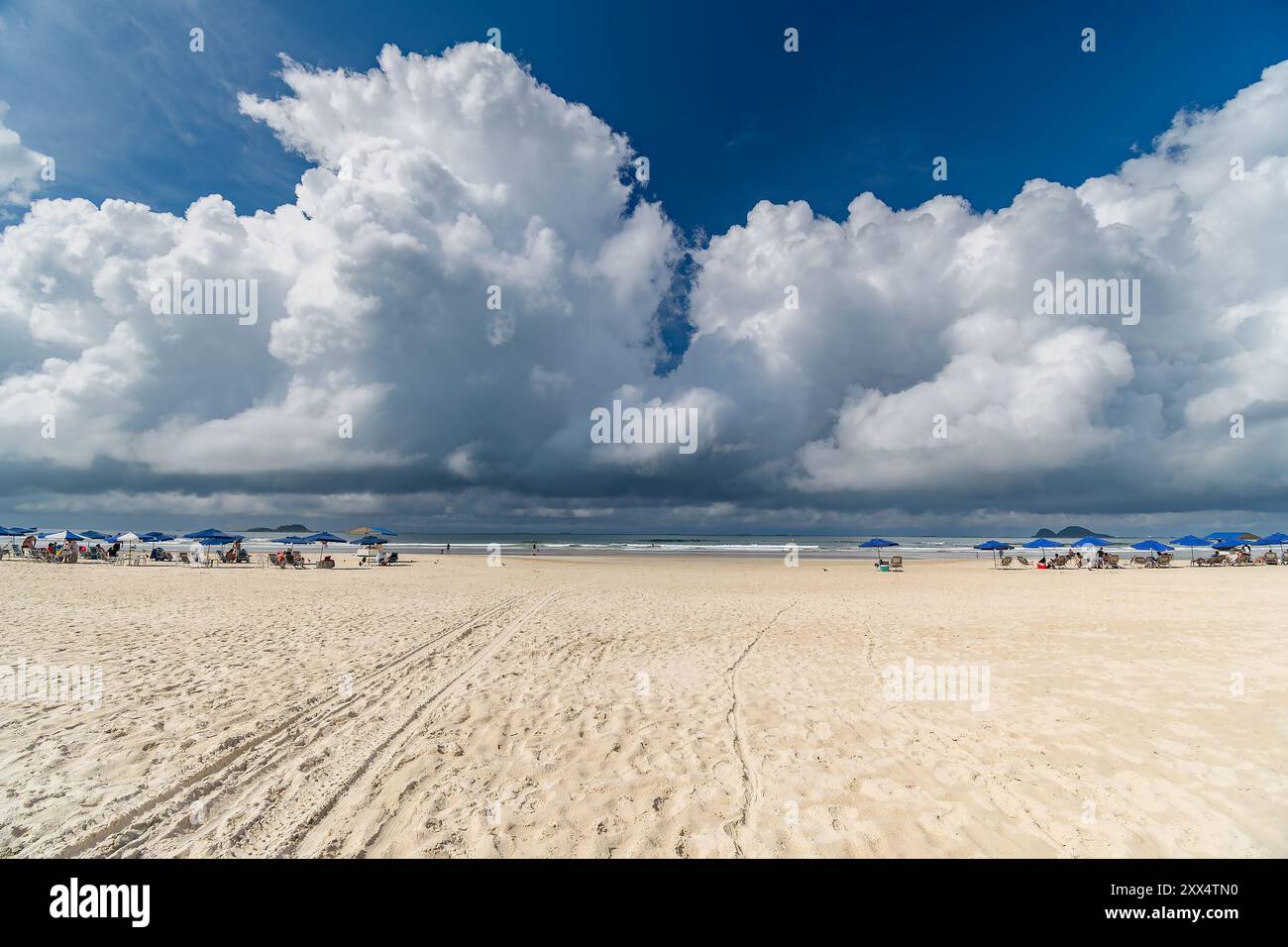 Morning at Enseada Beach on a beautiful sunny day with some rain clouds ...
