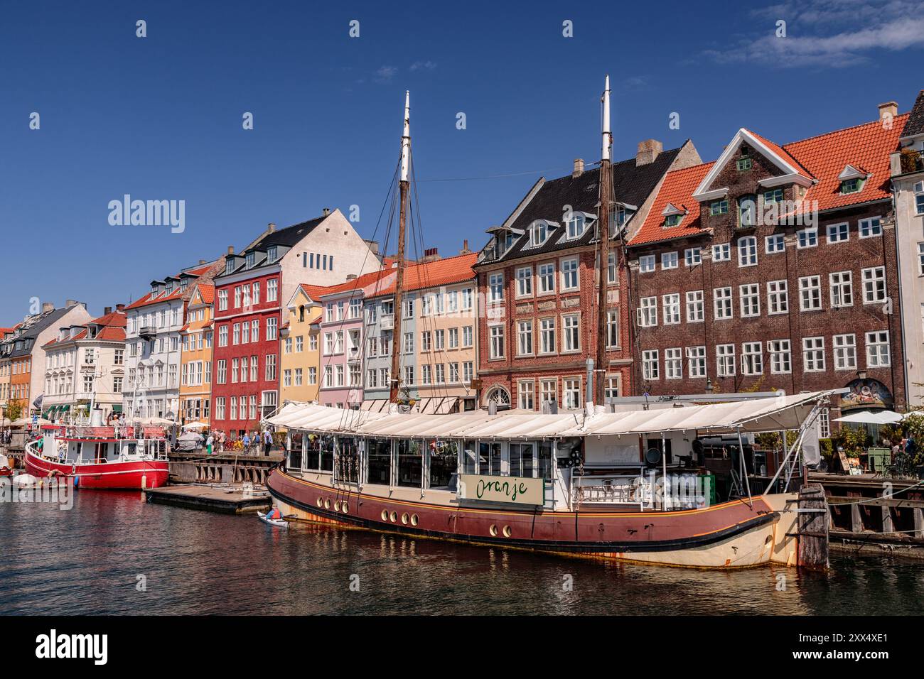 Colourful waterfront buildings and boats at Nyhavn, Copenhagen, Denmark ...