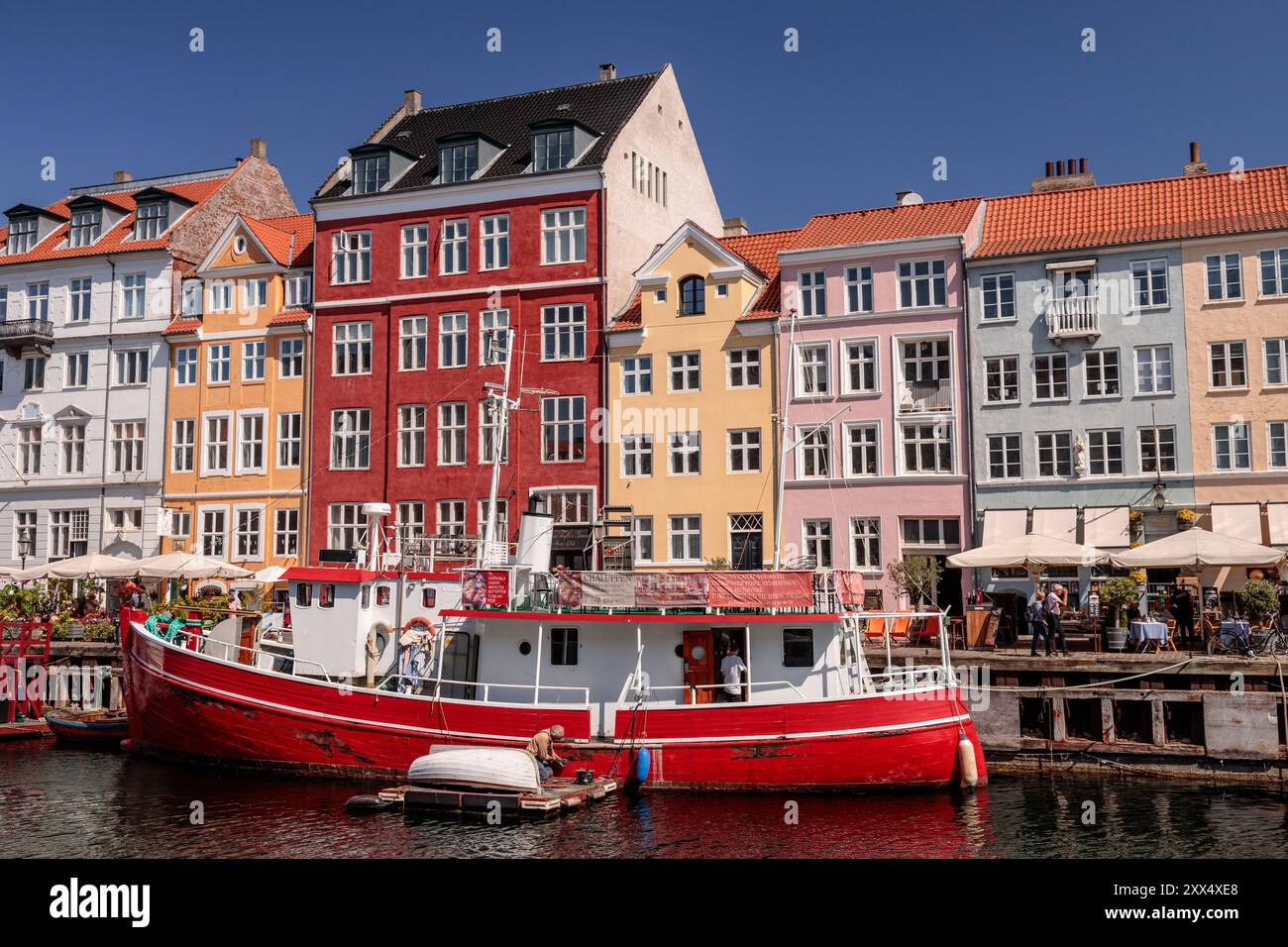 Colourful waterfront buildings and boats at Nyhavn, Copenhagen, Denmark ...