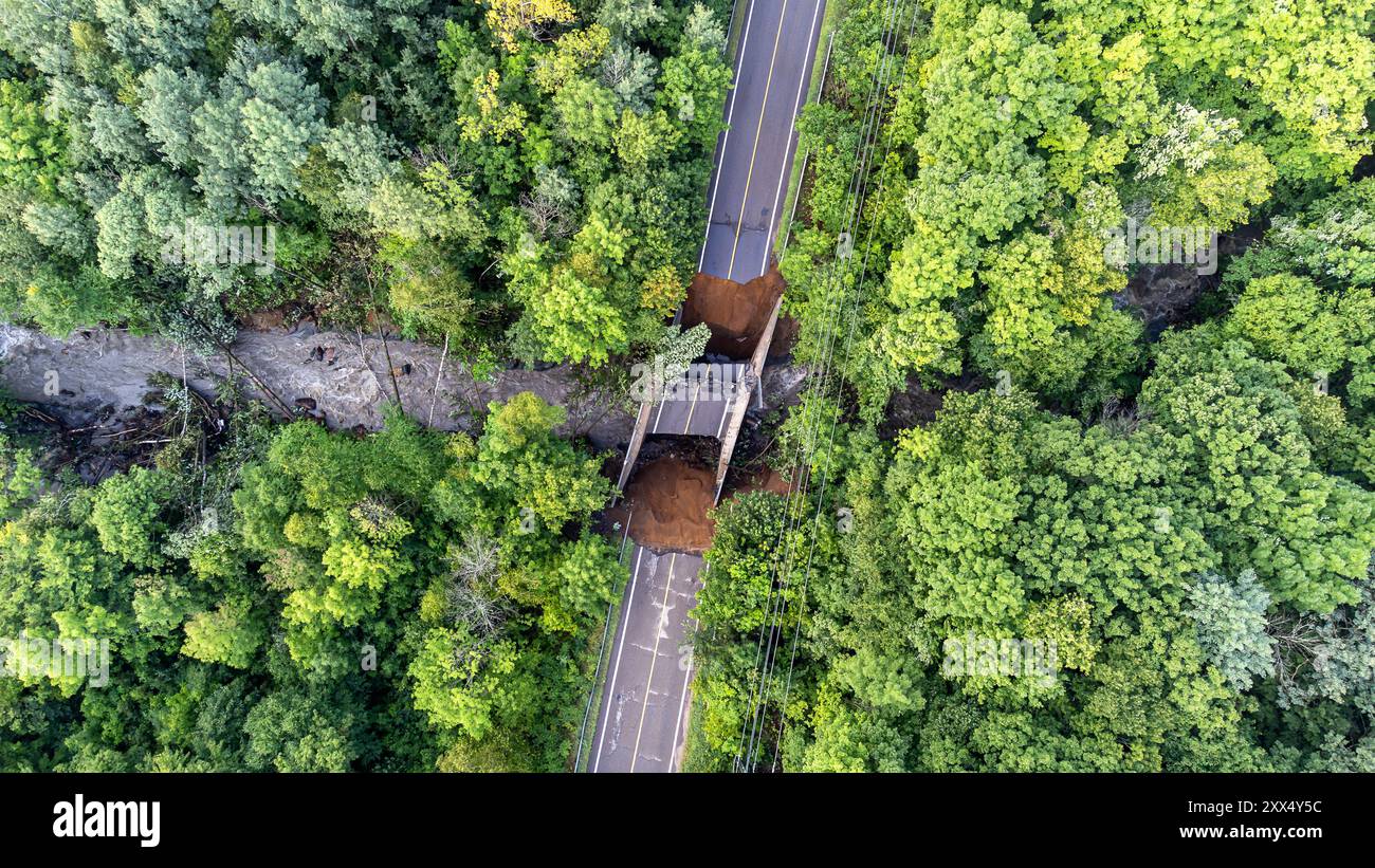 Aerial view of river, road and bridge destroyed by the heavy rain and ...