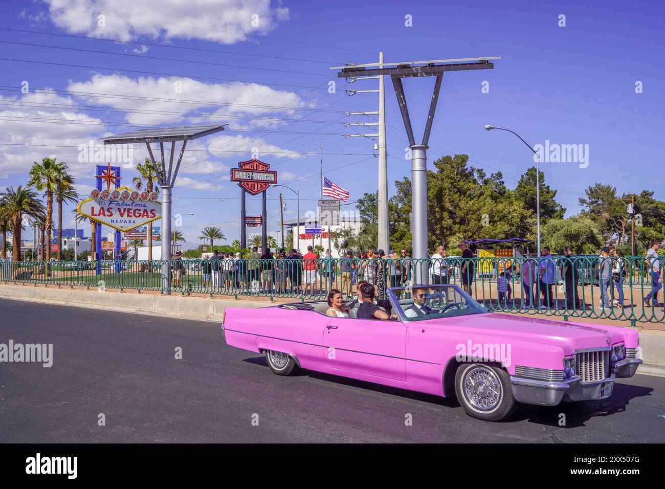 The pink vintage convertible car nearby the famous "Welcome to Las ...