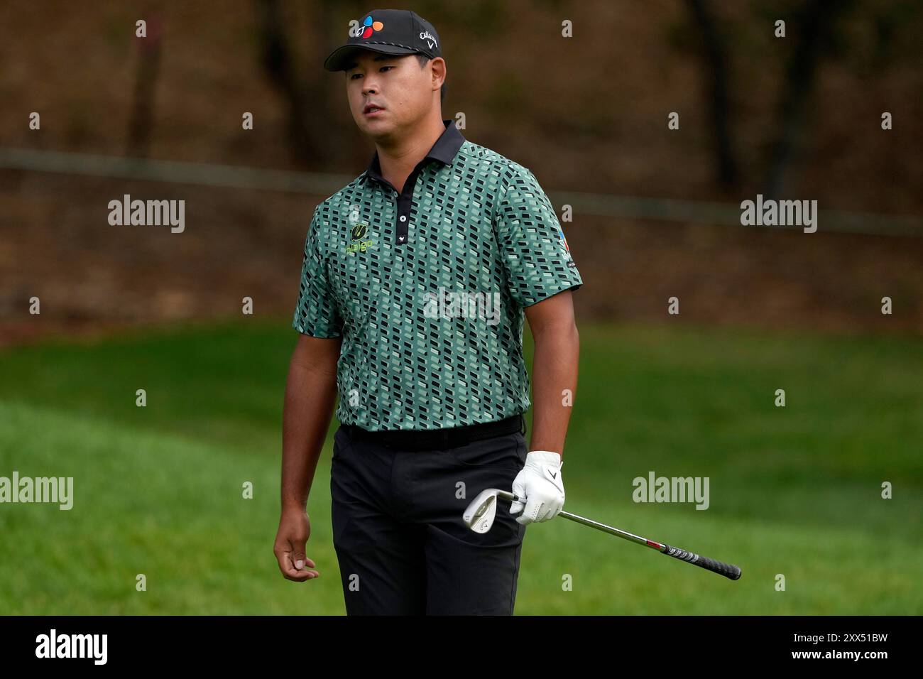 Si Woo Kim, of South Korea, watches his shot on the first green during ...