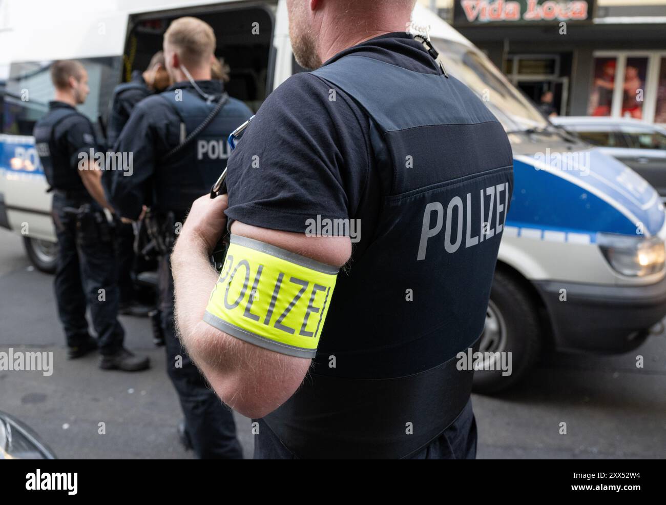 22 August 2024, Hesse, Frankfurt/Main: Police officers stand in front ...