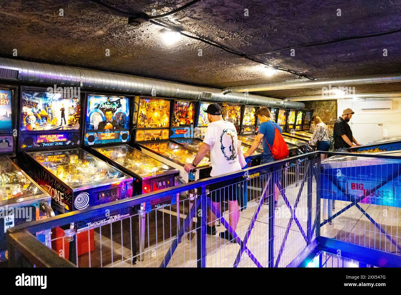 People playing on pinball machines at Interactive Museum of Pinball ...