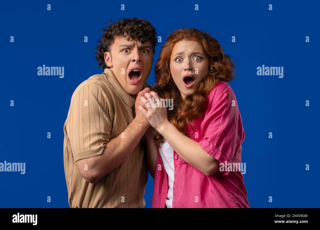 Frightened white american couple afraid of something. Man and woman in ...