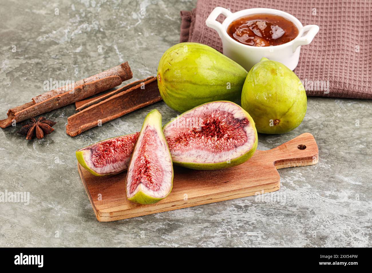 Tropical exotic green fig with cut over board Stock Photo - Alamy