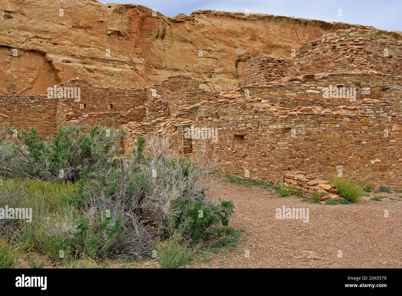 Stone slab masonry ruins set against sandstone cliffs at Chaco Culture ...