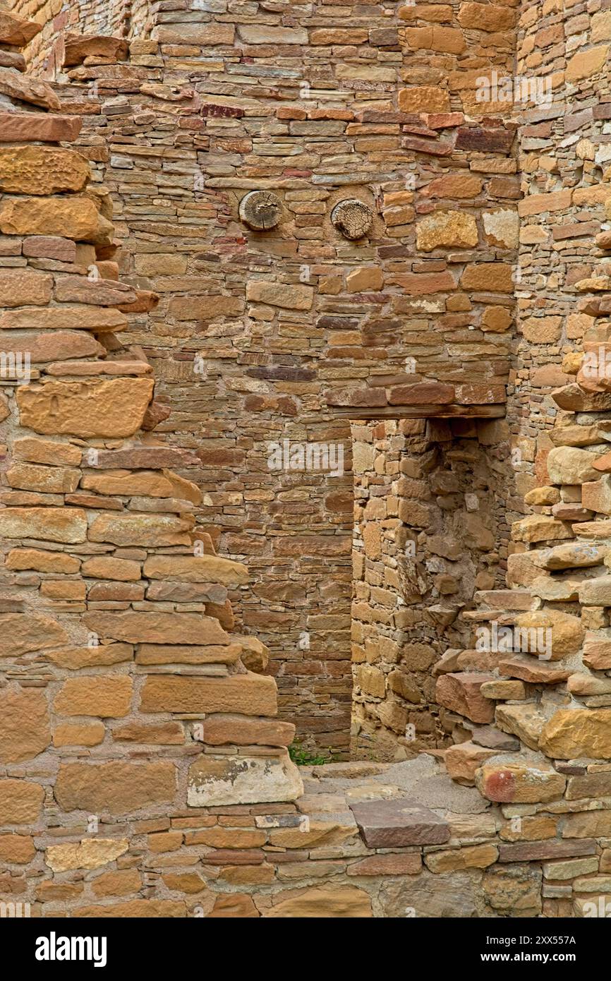 Doorway through stone masonry ruins with timber viga beams above at ...