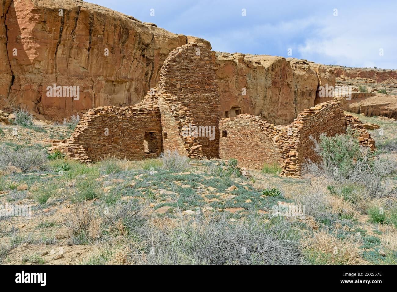 Stone slab masonry ruins set against sandstone cliffs at Chaco Culture ...