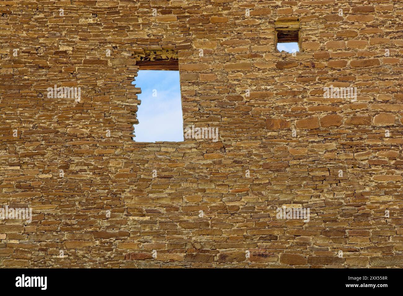 Windows through stone masonry ruins exposing double wall construction ...