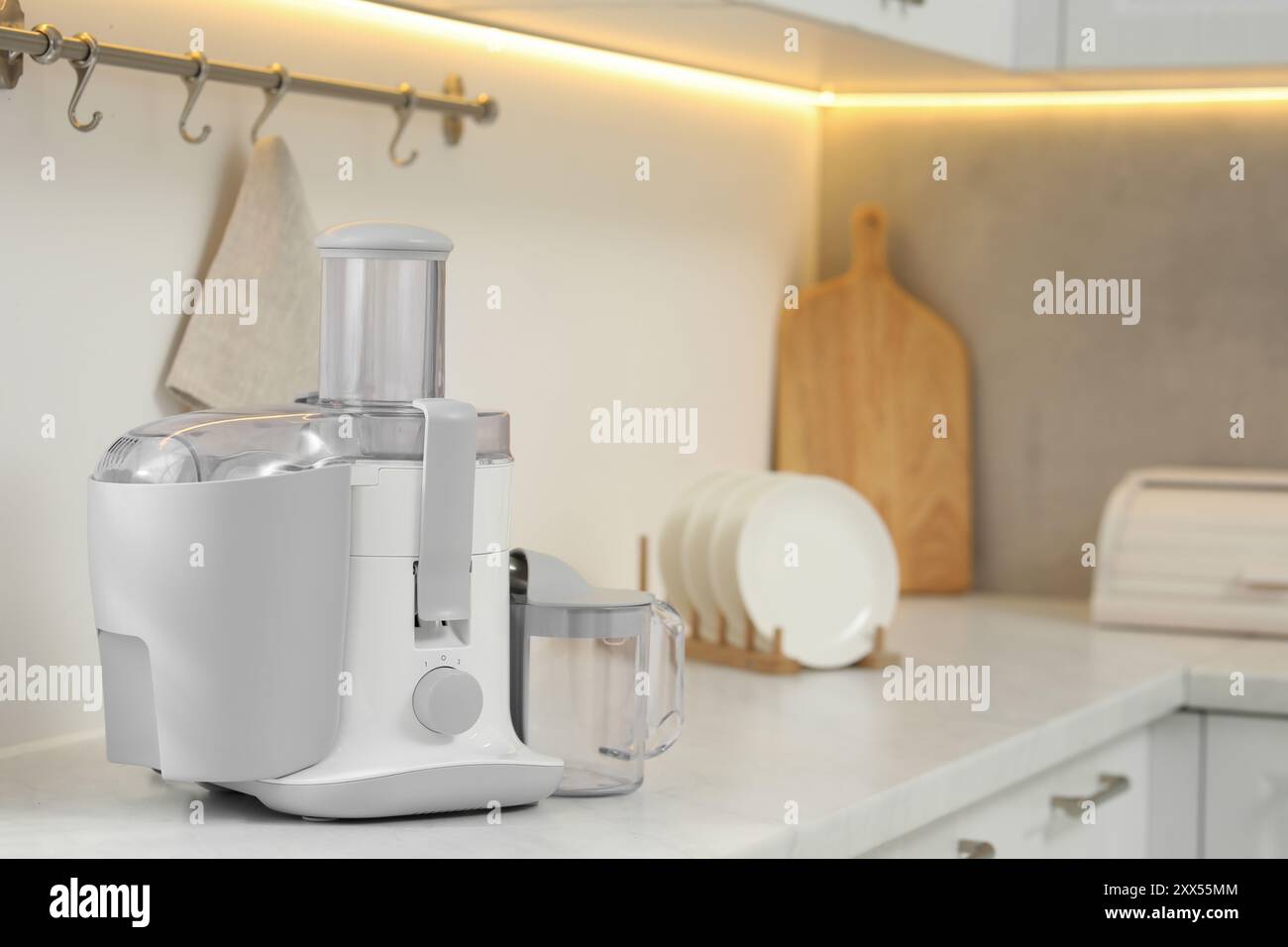 Modern juicer on white marble counter in kitchen Stock Photo - Alamy