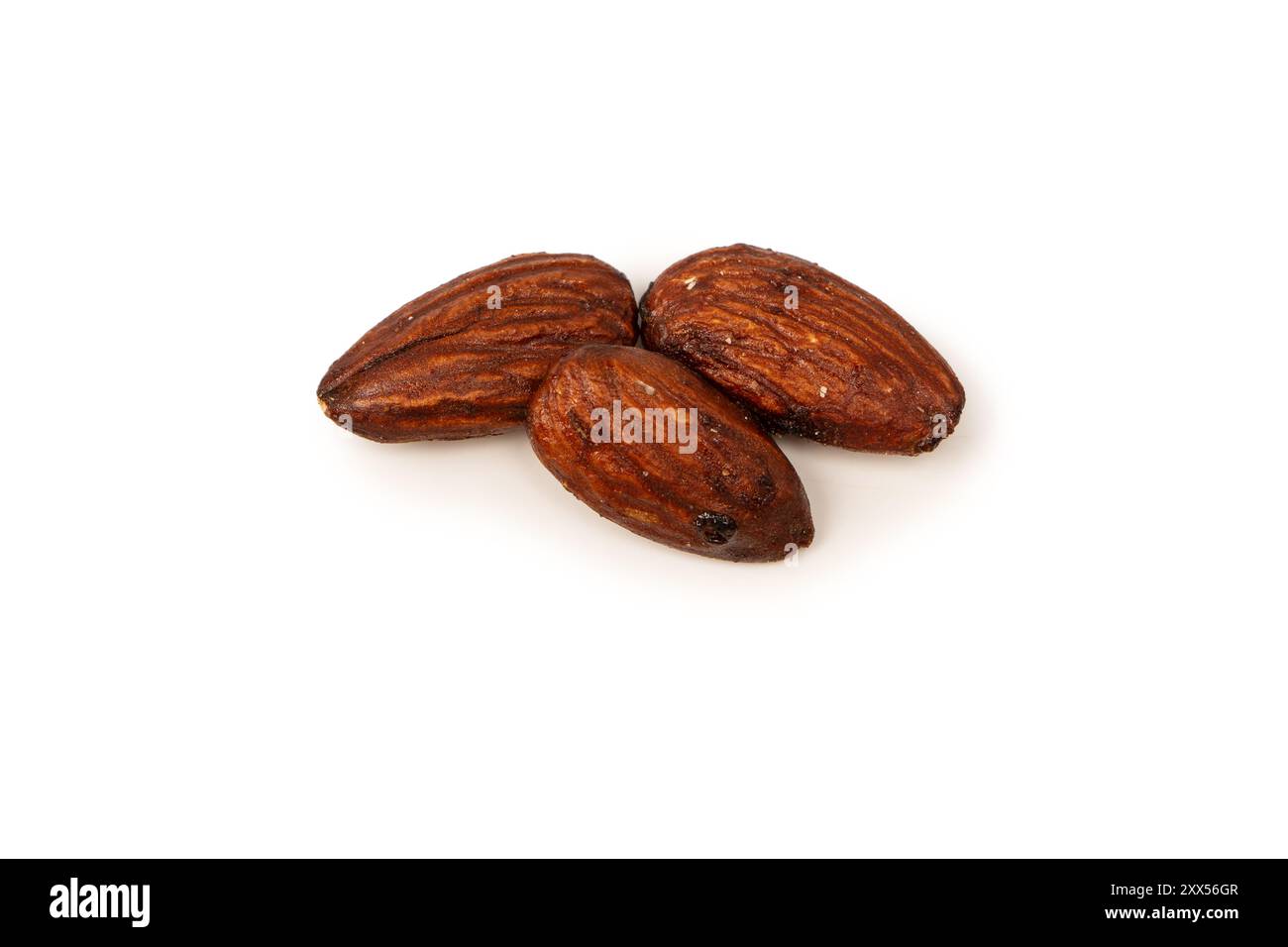 A group of caramelized almonds isolated on a white background Stock ...