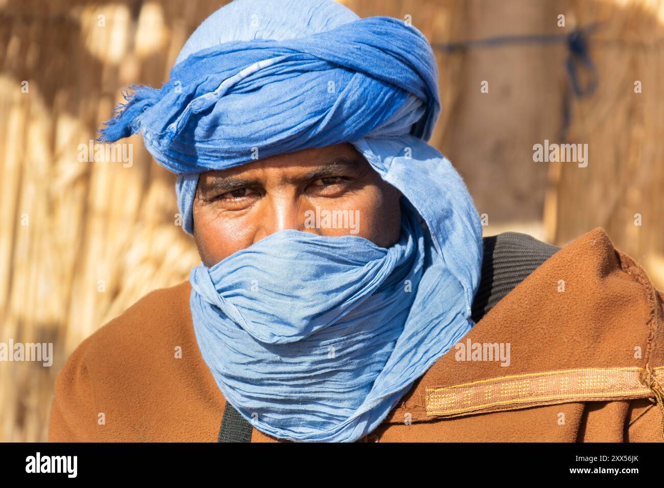 Portrait of tuareg man local guide in the Sahara desert under sunlight ...