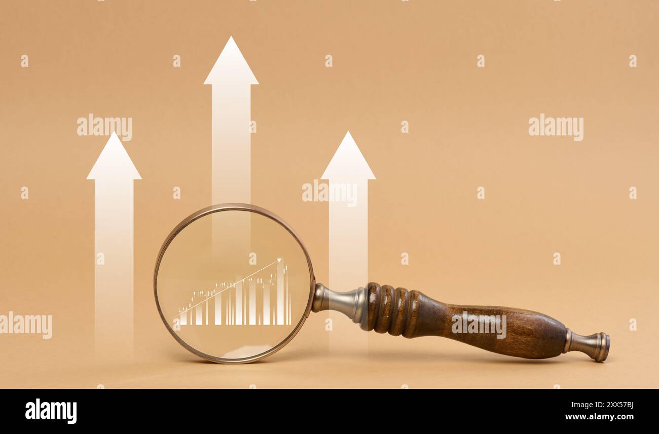 Magnifying glass and graph on brown background, business indicators ...