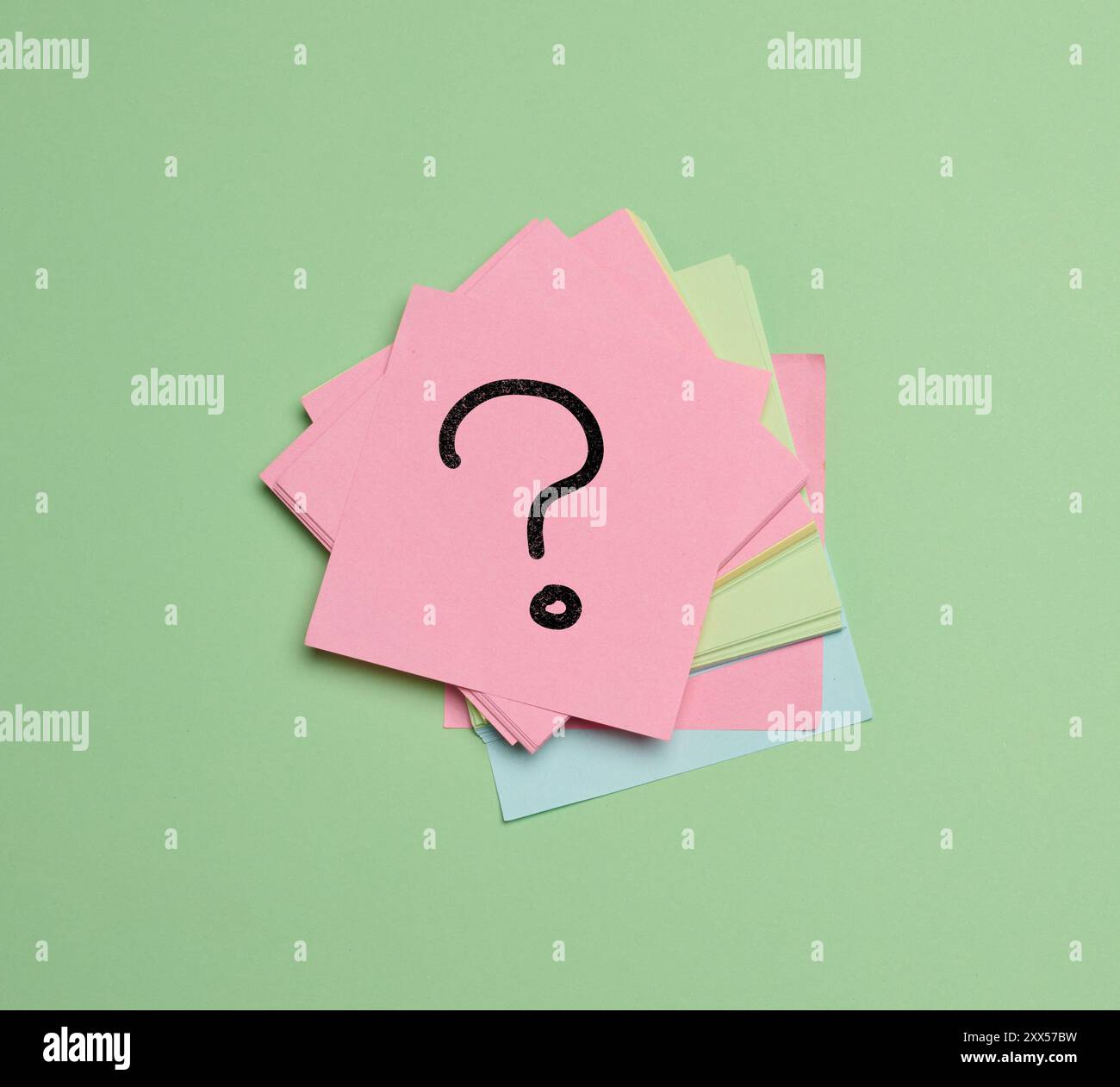 Drawn question marks on stickers, green background. Searching for truth ...