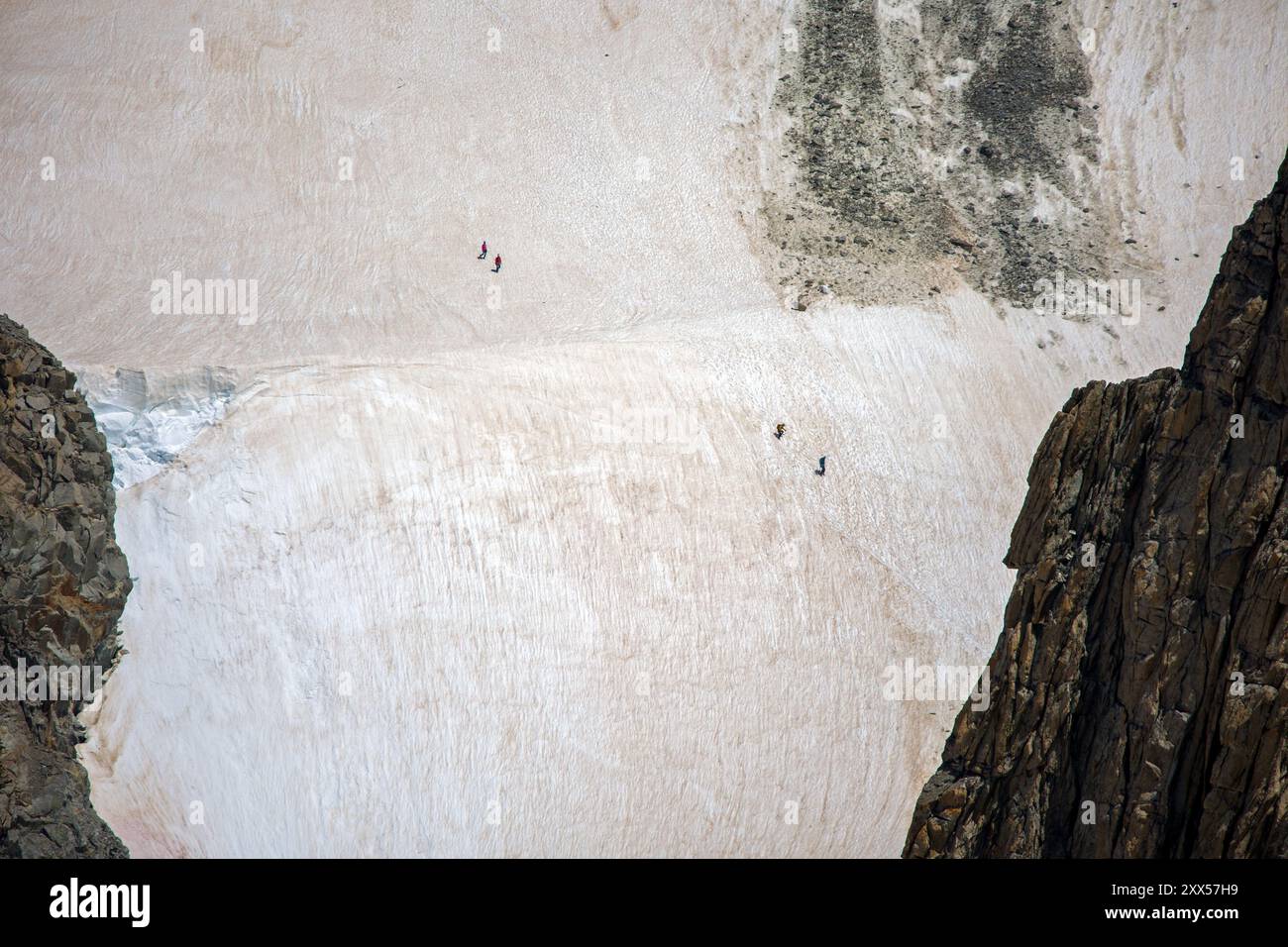 a group of alpinists in the alps on a snow slope covered with sahara ...